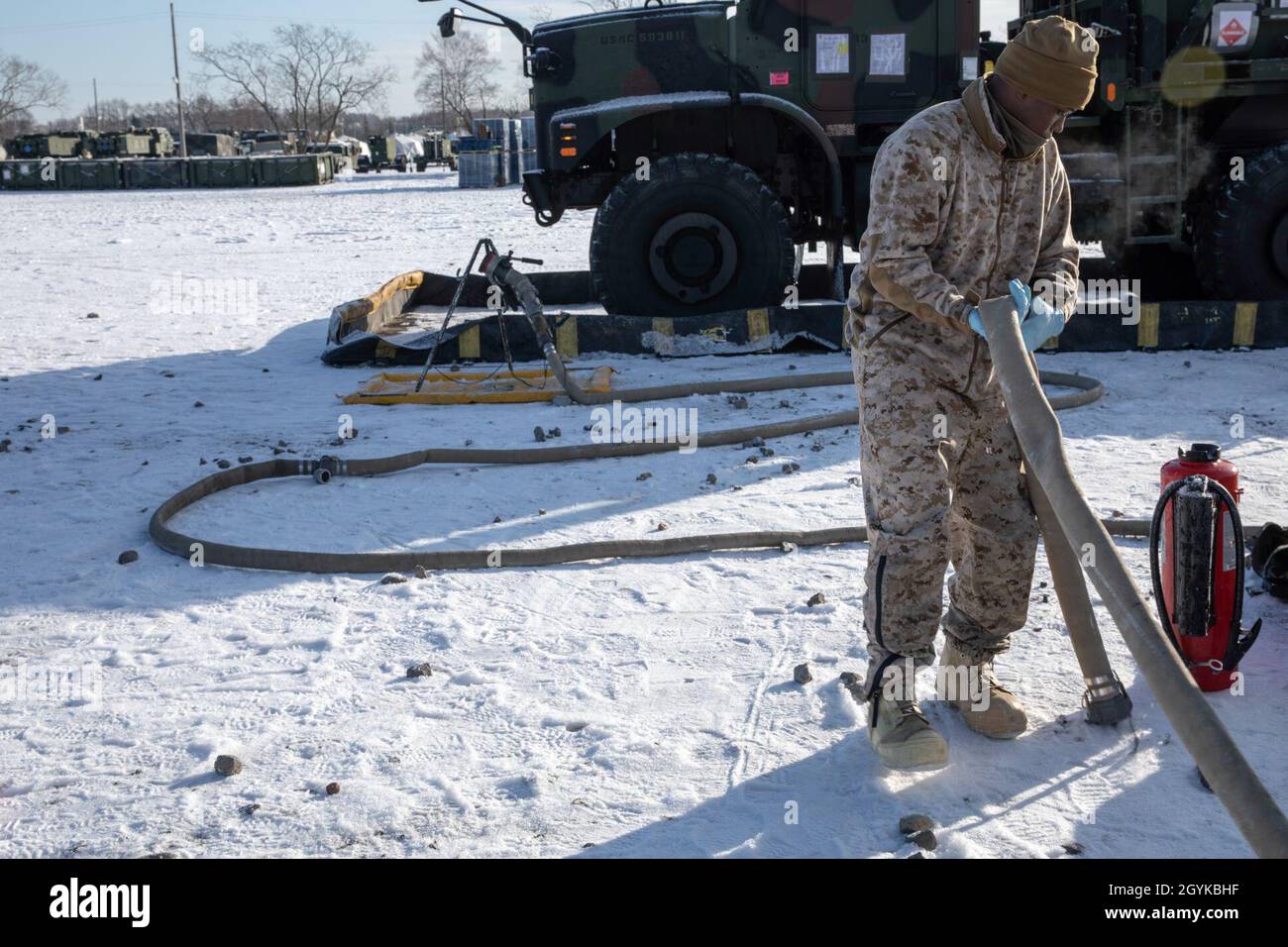 U.S. Marine Corps Sgt. David Millwood unravels a fuel hose during ...