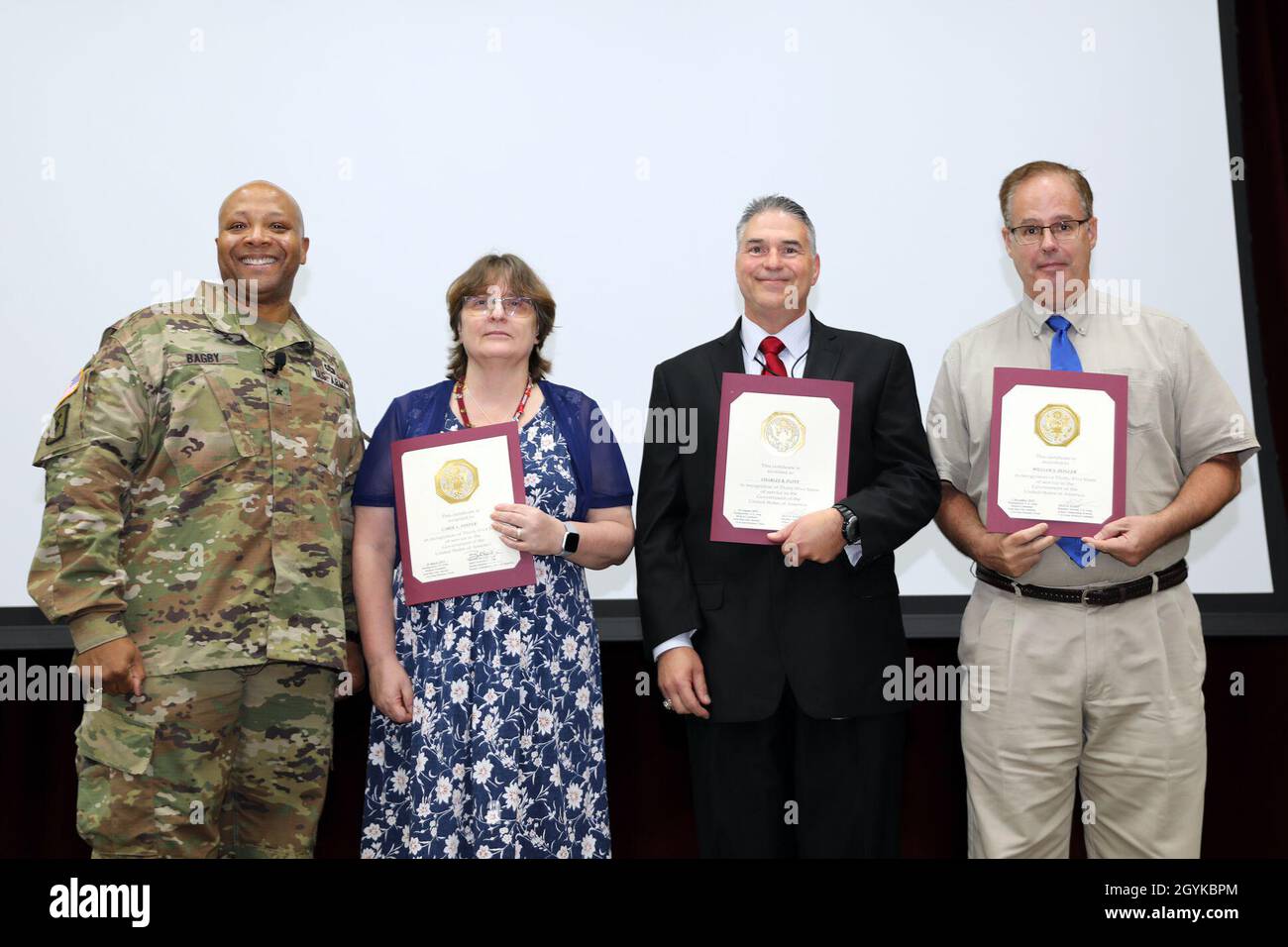 Brig. Gen. Shan K. Bagby presents awards to Carol Foster, Charles Patty ...