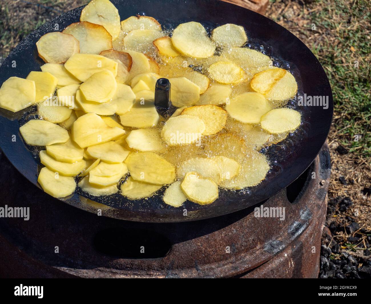 High angle shot of natural potato chips being made on a dutch oven ...