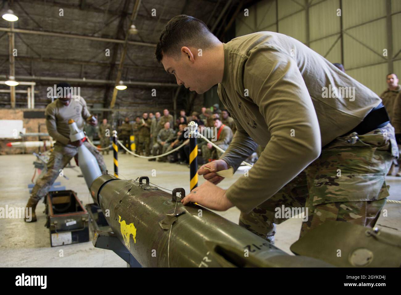 Airmen assigned to the 36th Aircraft Maintenance Unit prepare munitions ...