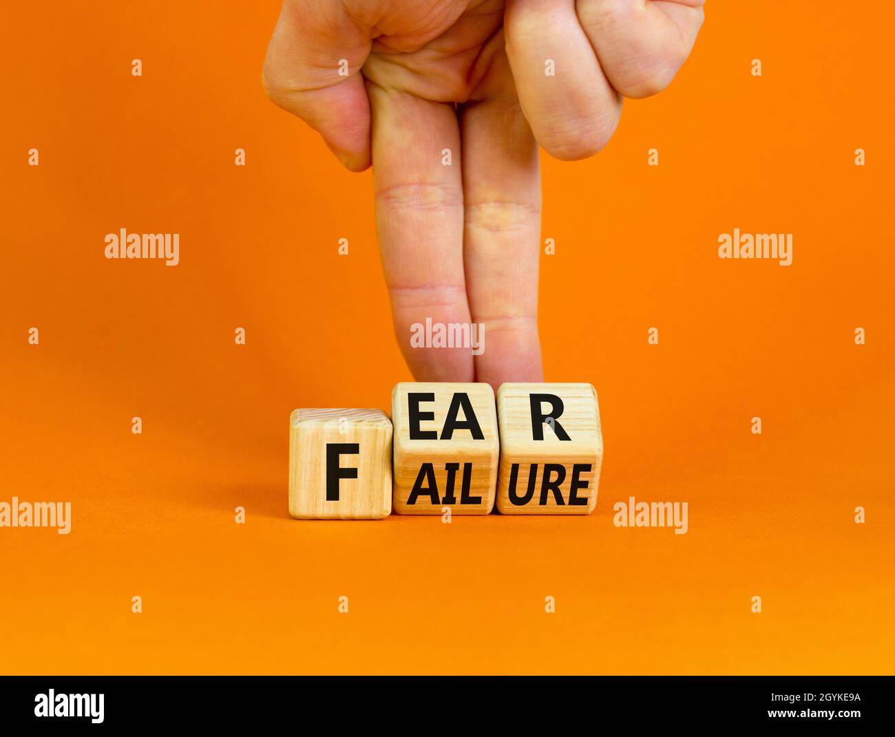 Fear of failure symbol. Businessman turns wooden cubes and changes the ...