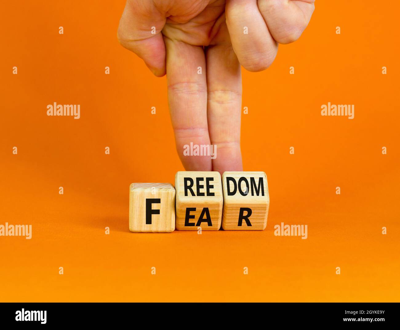 Freedom from fear symbol. Businessman turns wooden cubes and changes ...