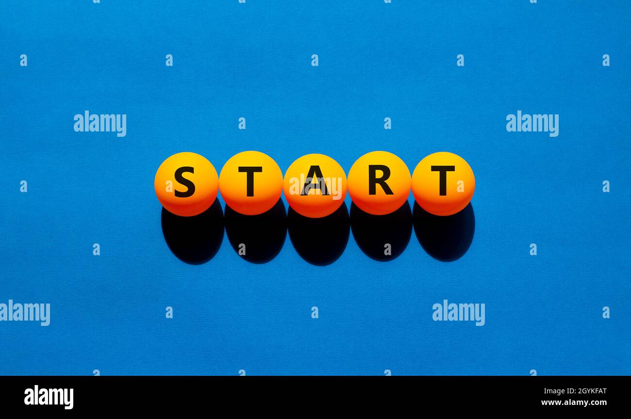 Start symbol. The concept word 'start' on orange table tennis balls ...