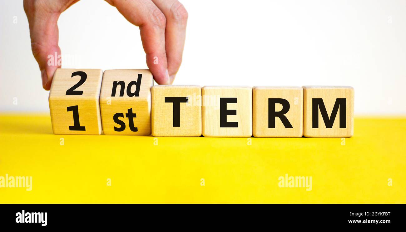 First or second term symbol. Businessman turns wooden cubes and changes ...