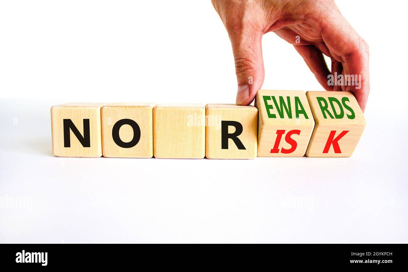 No risk and rewards symbol. Businessman turns wooden cubes and changes ...