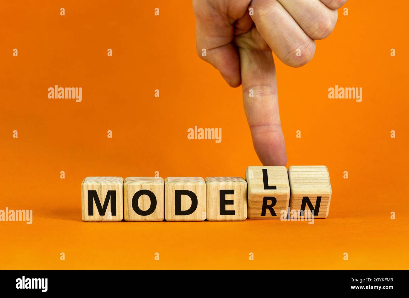 Modern model symbol. Businessman turns wooden cubes and changes the ...