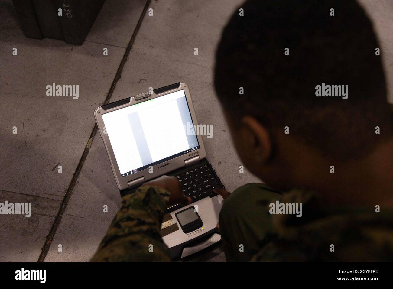 Lance Cpl. Harvie Halliburton looks over publications for the AV-8B ...