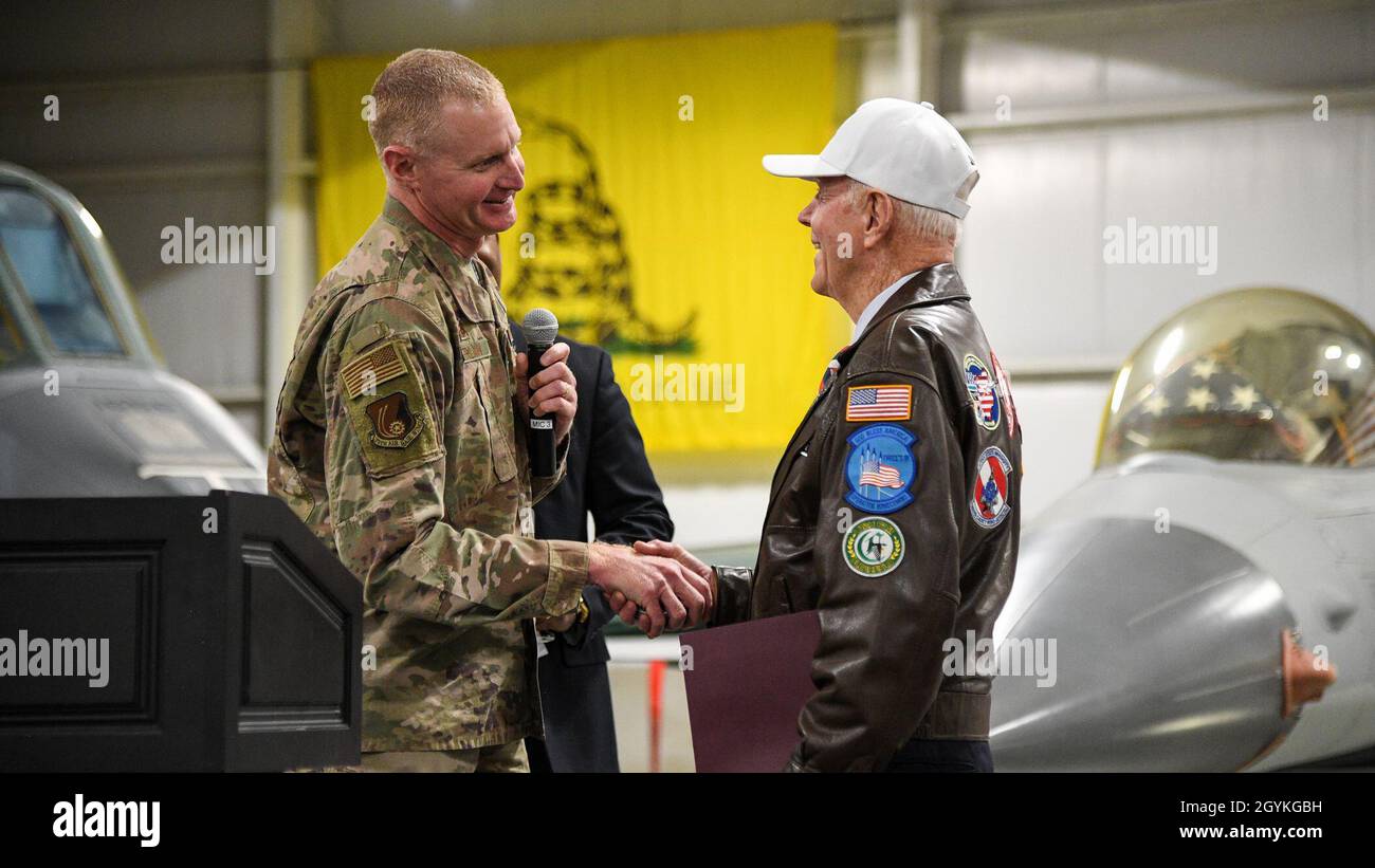 Col. Jon Eberlan, 75th Air Base Wing commander, presents retired Air Force Lt. Col. Jay Hess ...