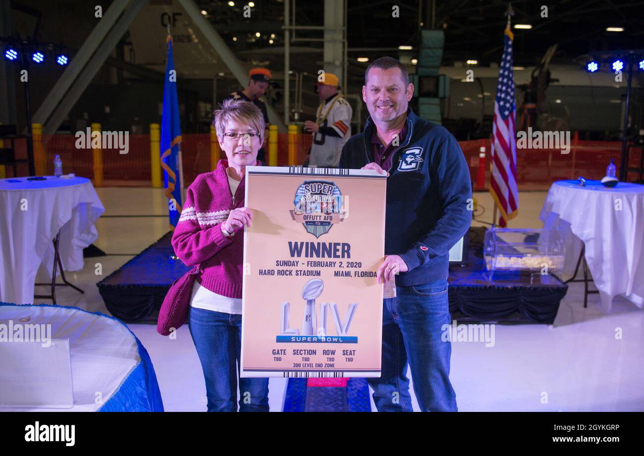 Karen and Brian Newton, Super Saturday attendees, stand with a giant ...
