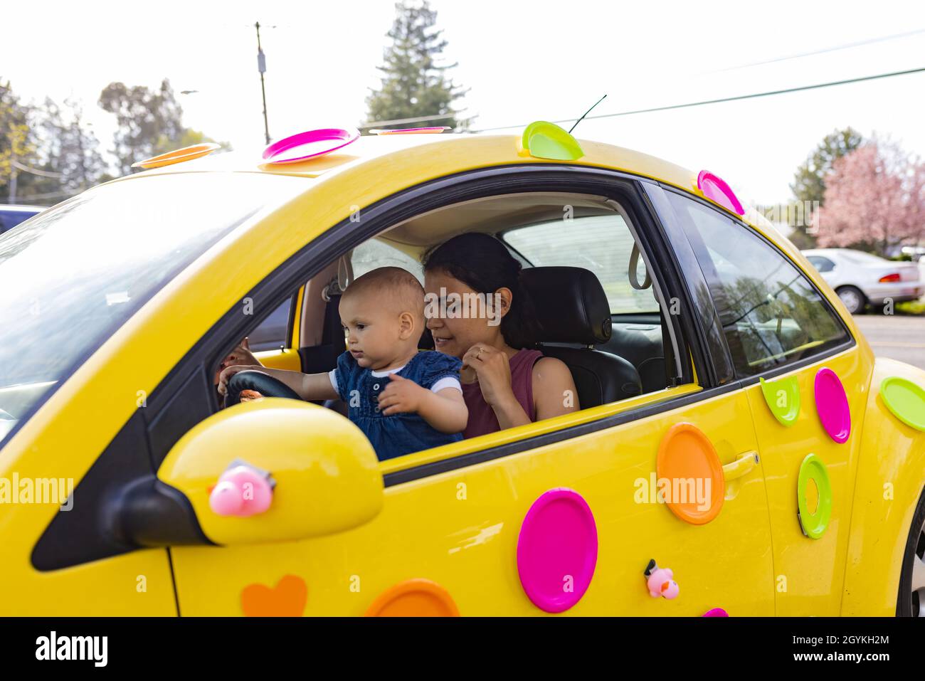 Happy mother and her adorable baby in colorful slug bug decorated for ...