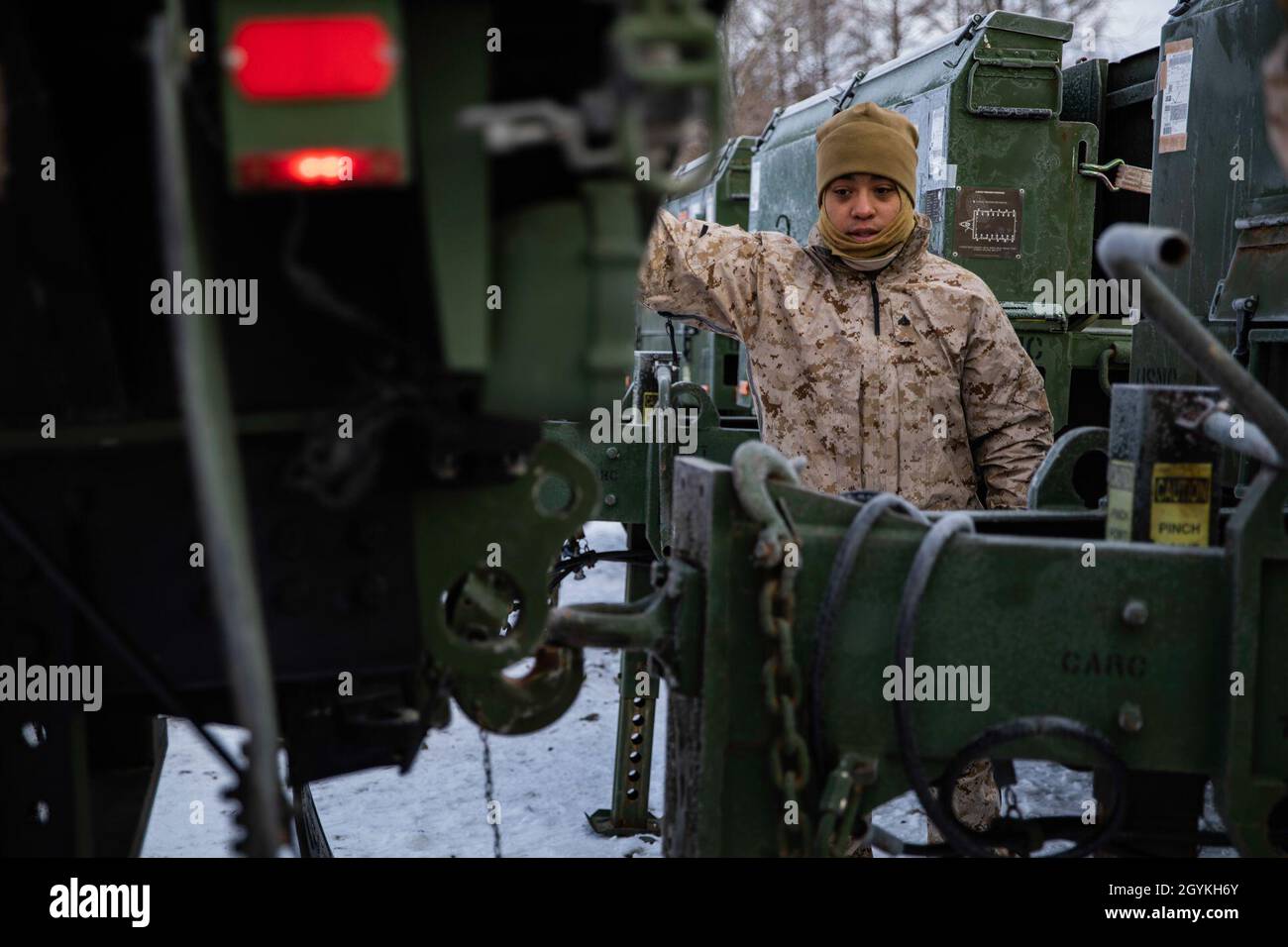 U.S. Marine Corps Cpl. Taylor English directs an operator to back into ...