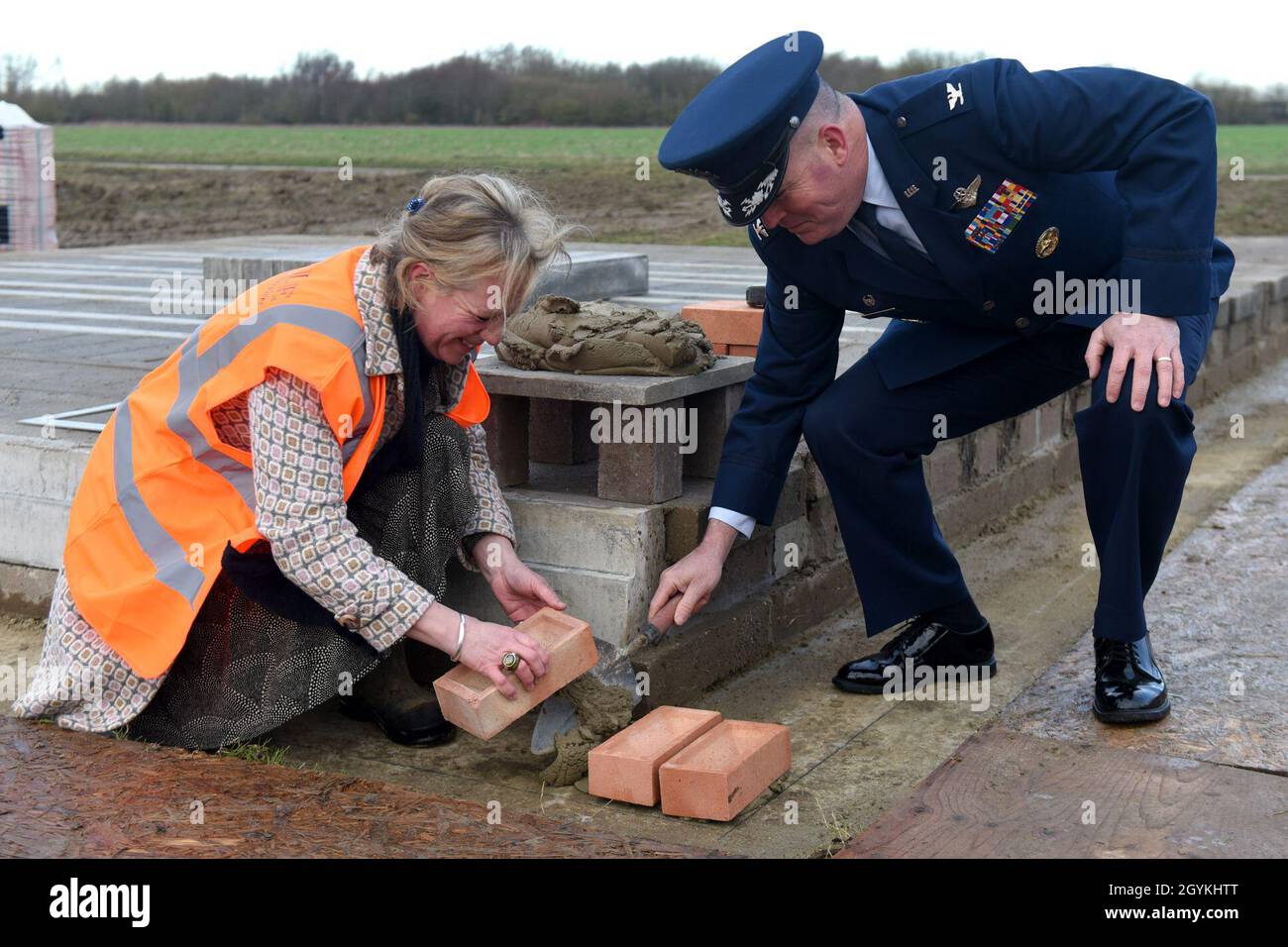 Col. Will Marshall, 48th Fighter Wing commander, helps lay down a brick ...