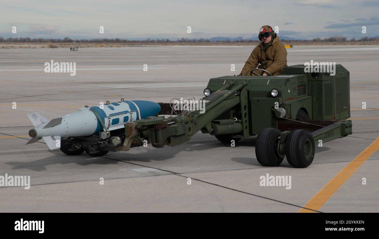 Lance Cpl. Chad Clevenger operates a forklift carrying a training bomb ...