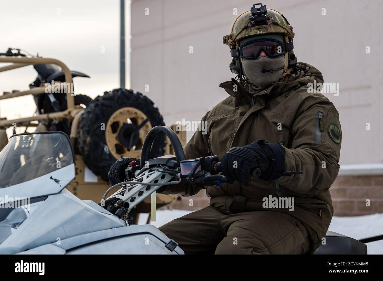 A French Joint Terminal Attack Controller prepares to load a snowmobile ...