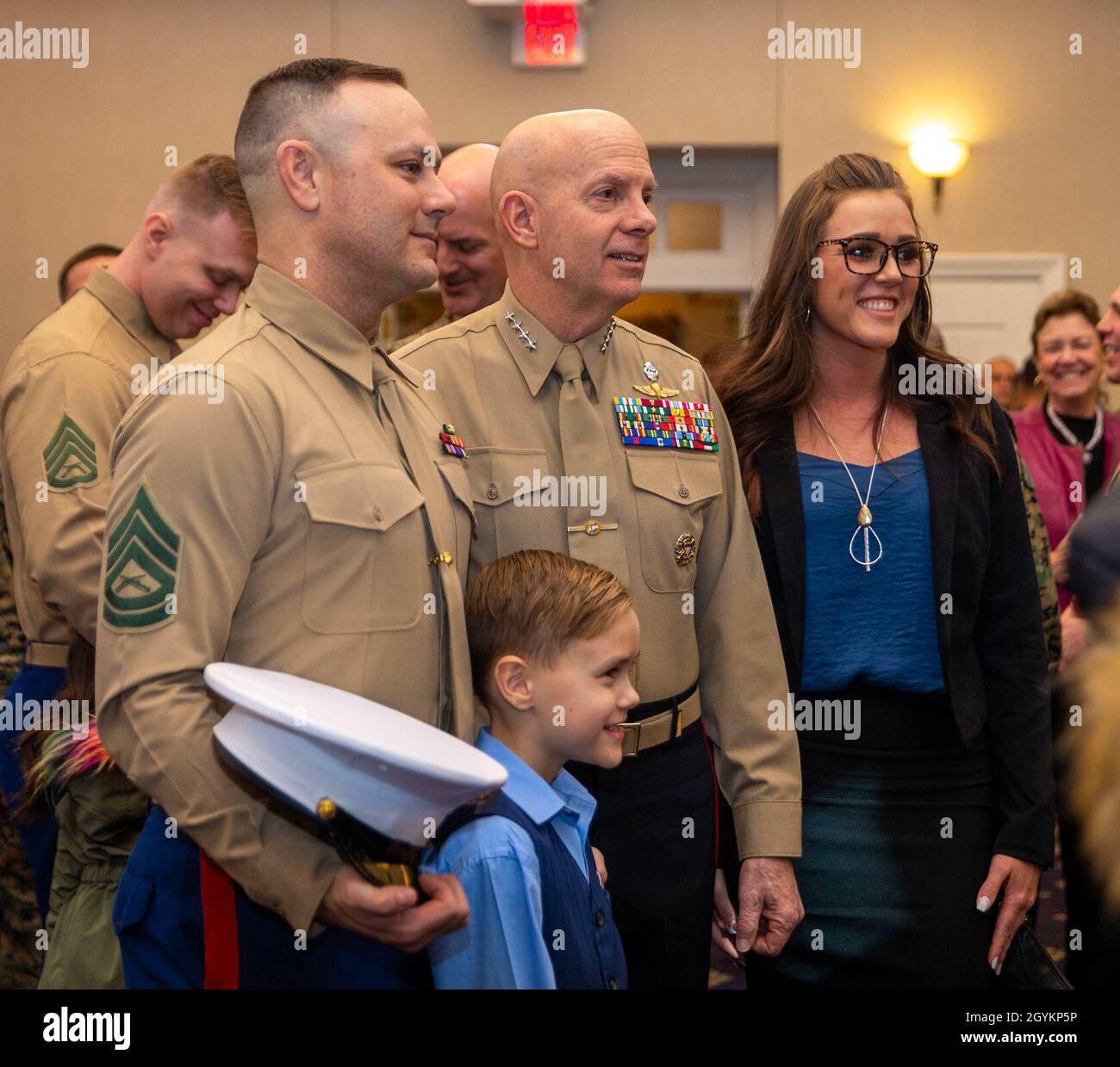 Gunnery Sgt. Michael Z. Brown and family pose with Gen. David H. Berger ...