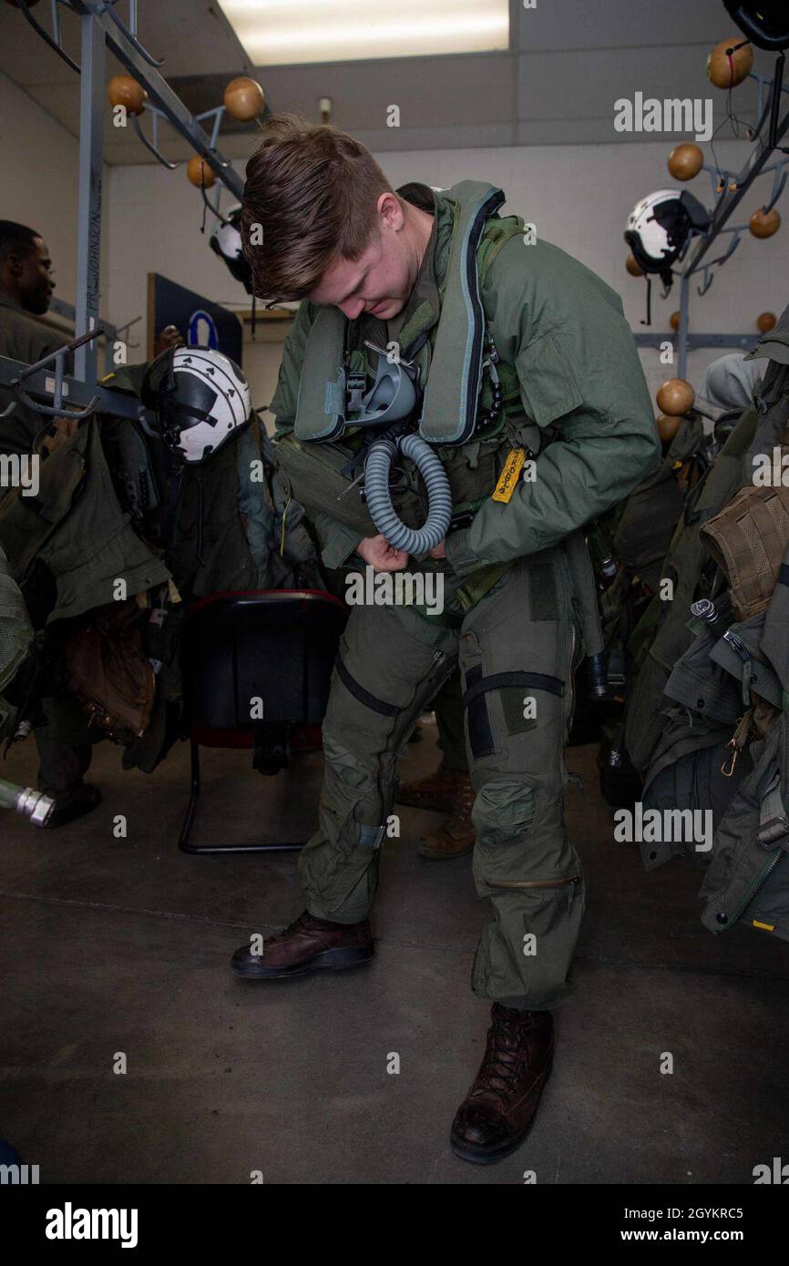 Marine Capt. Jonathan Roman puts on a hazard flight suit during cold ...