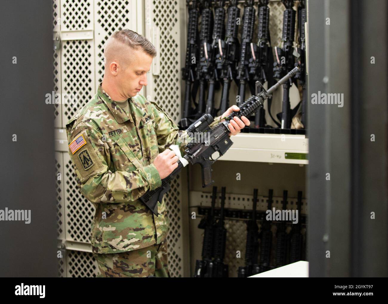 An 82nd Airborne Division Artillery armorer prepares an M4 carbine for ...