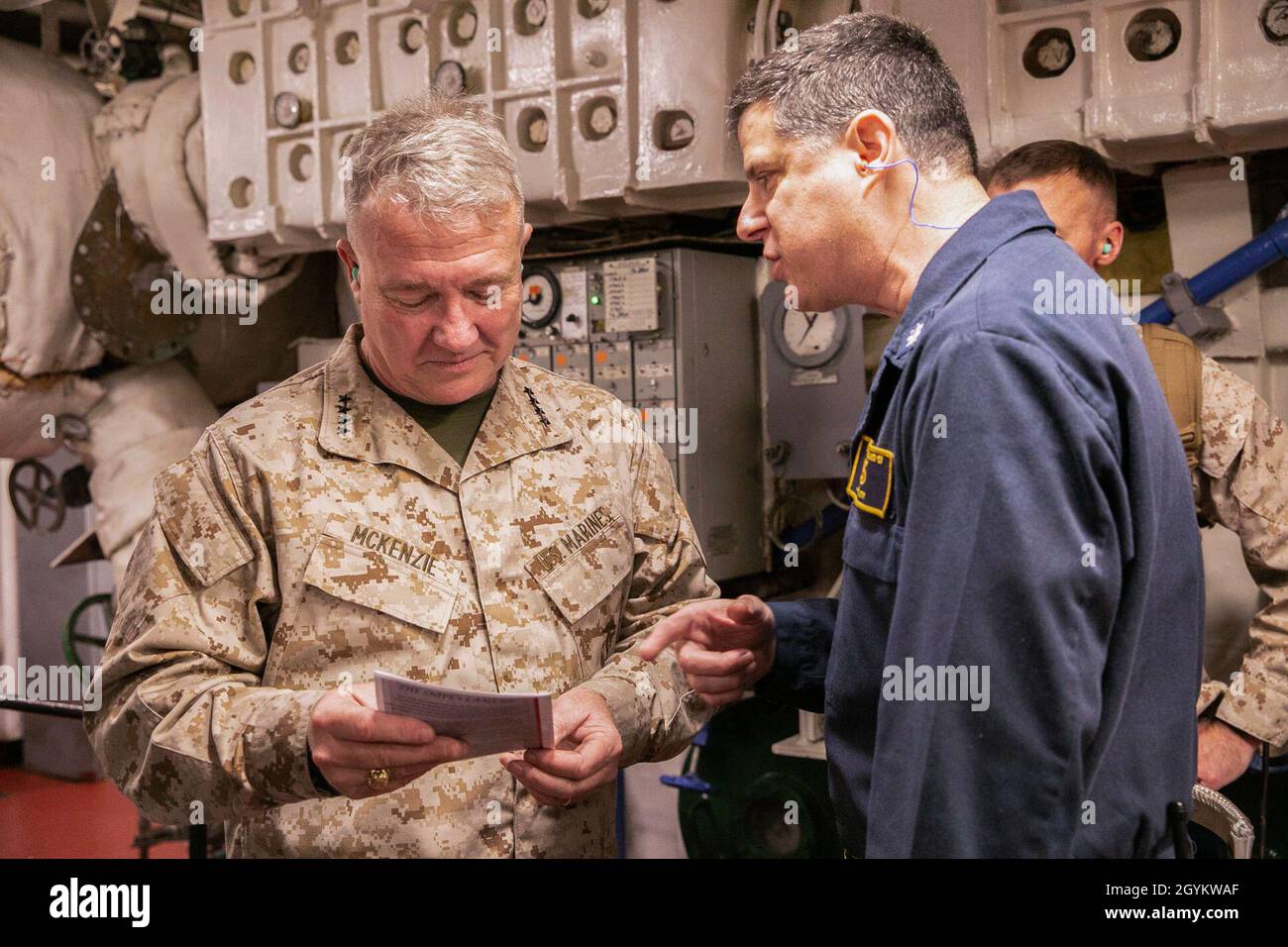 A U.S. Navy officer attached to USS Bataan (LHD 5), right, speaks to U ...