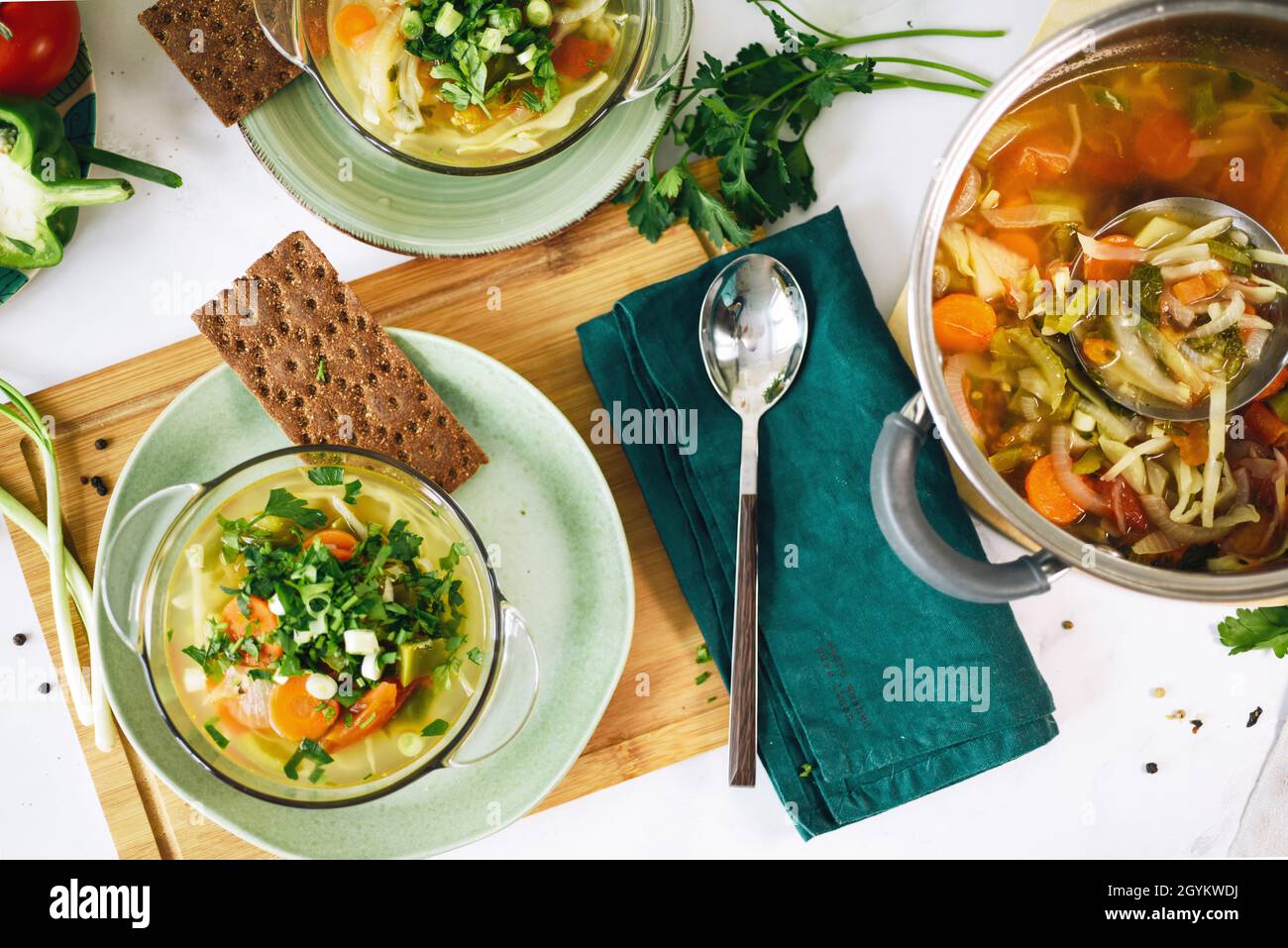 Two plates with vegan food, cabbage soup on the table at home setting ...