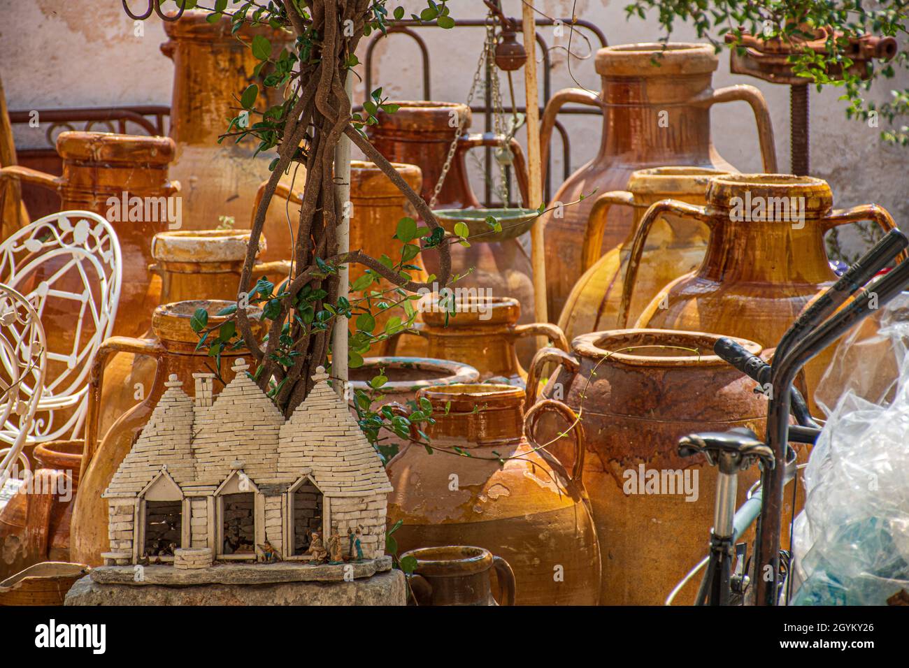 Typical Puglia ceramic jugs or jars and couple of Trulli souvenirs ...