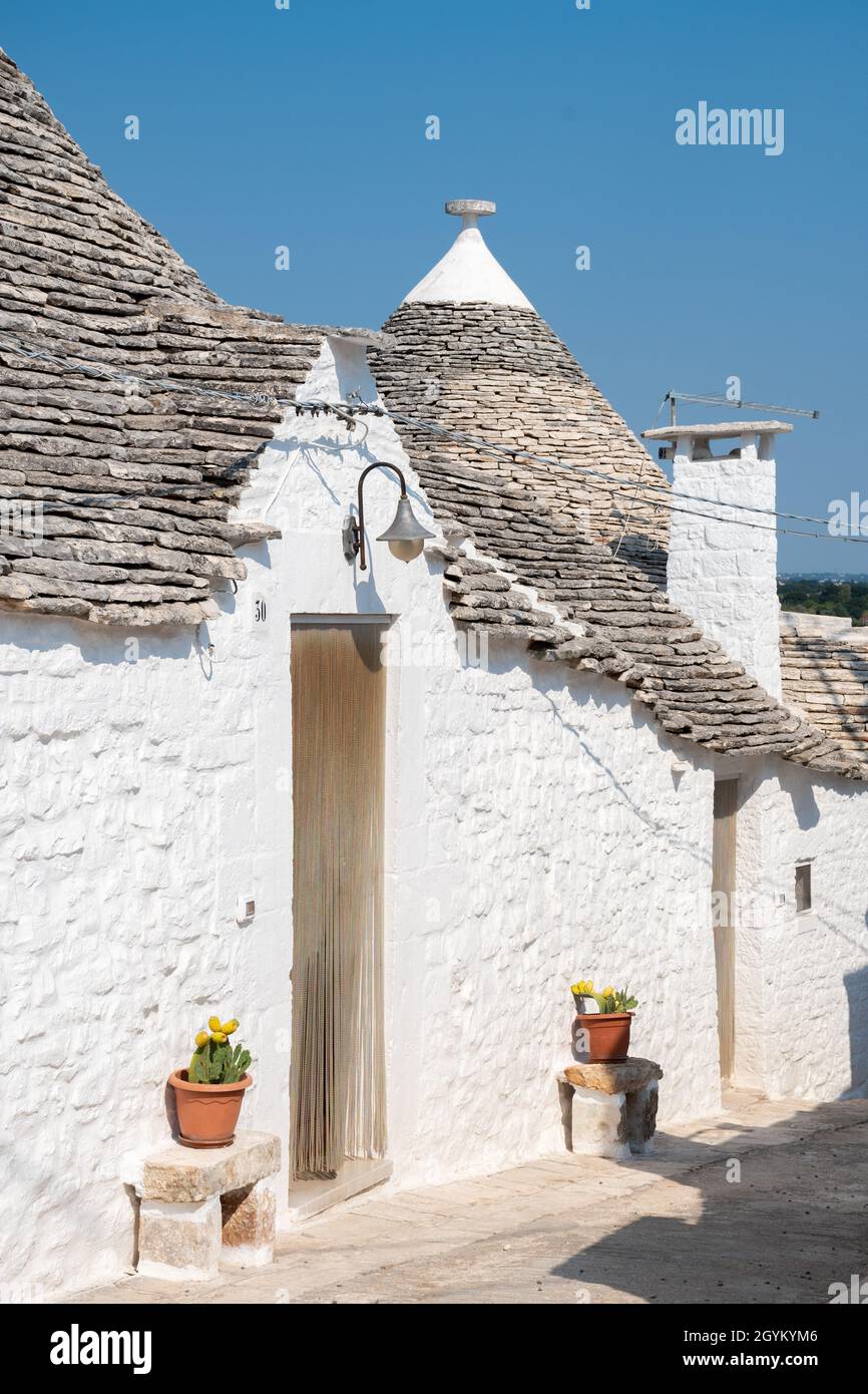 Group of beautiful Trulli, traditional Apulian dry stone wall hut old ...