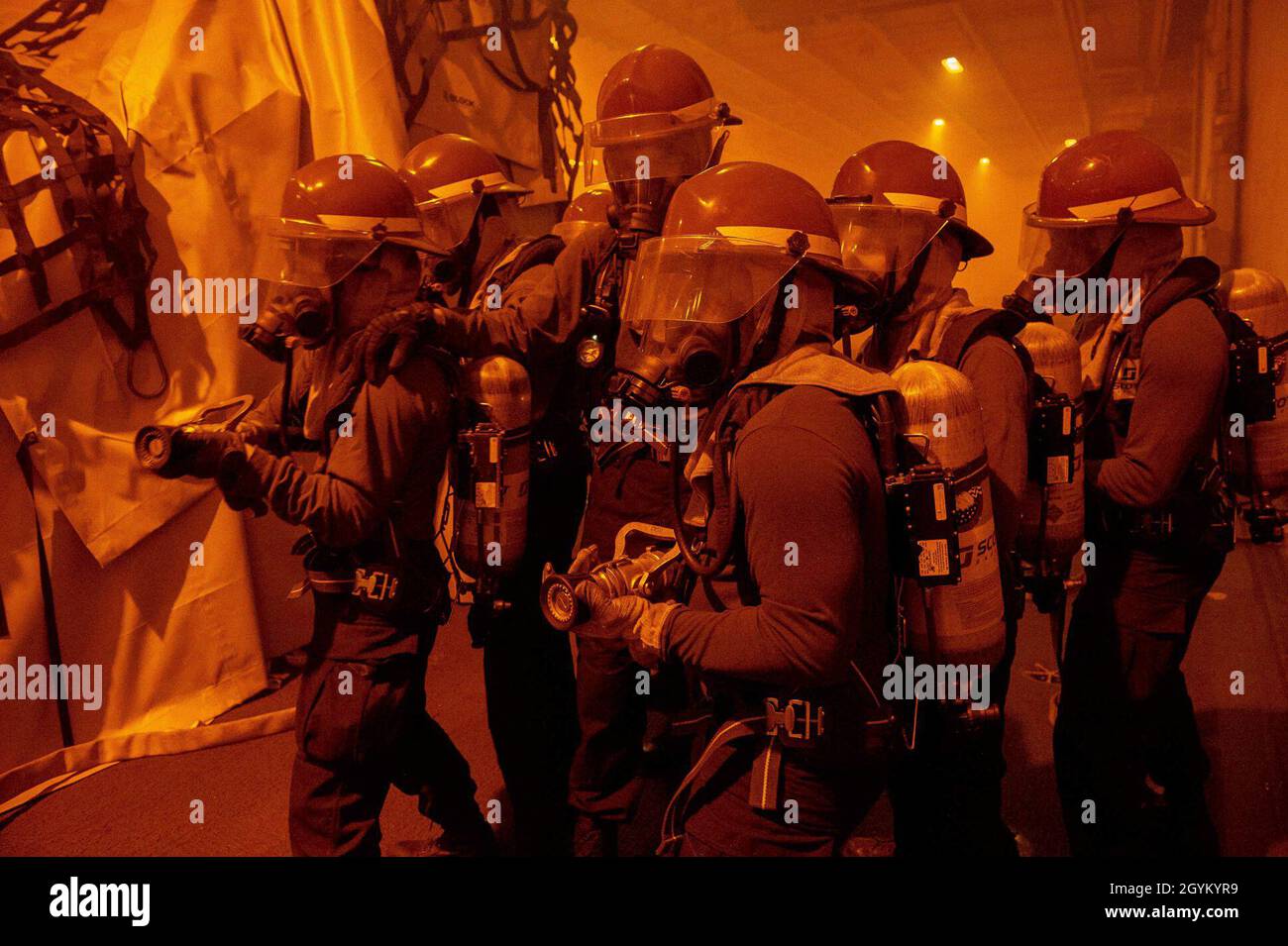PACIFIC OCEAN (Jan. 24) - Hose team members fight a simulated fire in ...