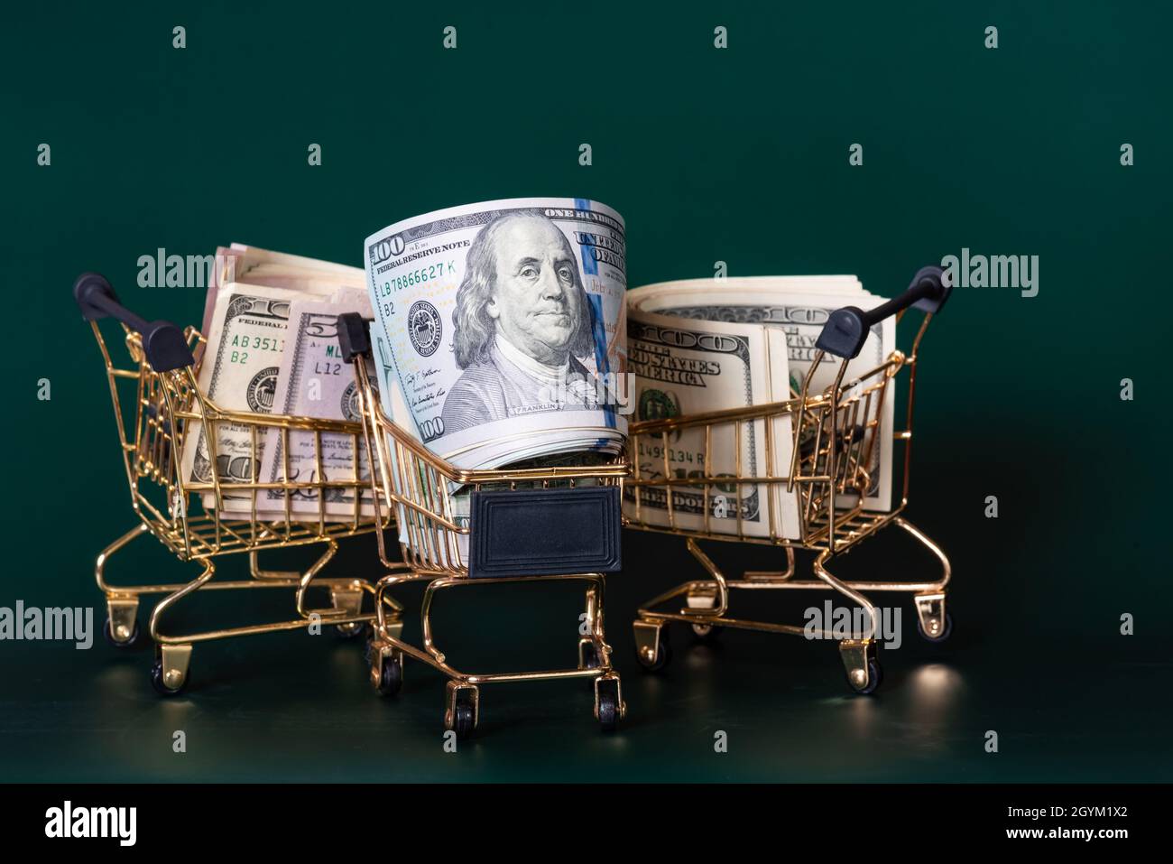 Banking and finance concept. Three gold-colored grocery carts with ...