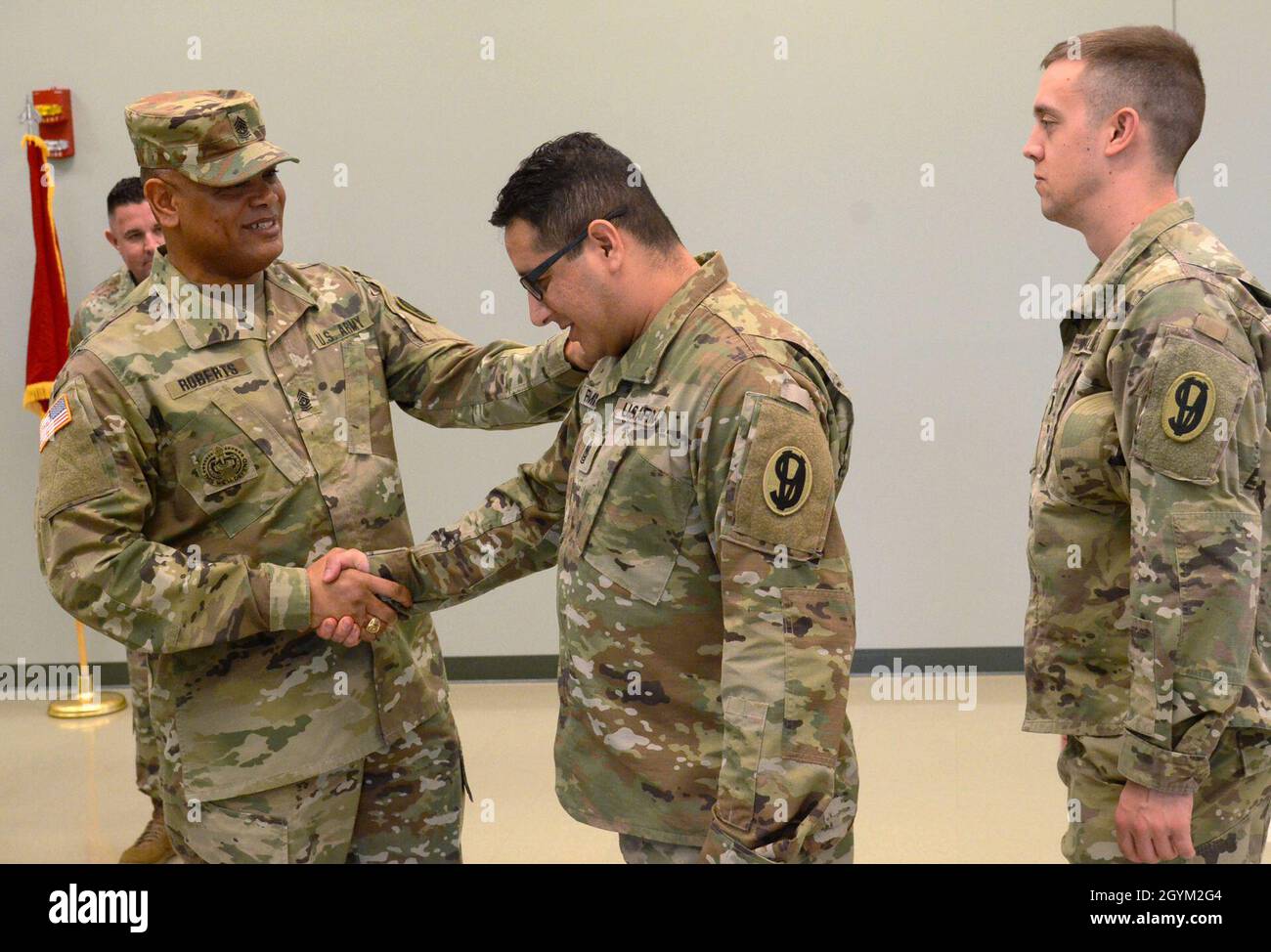 U.S. Army Reserve Command Sgt. Maj. Eric J. Roberts (left) greets ...