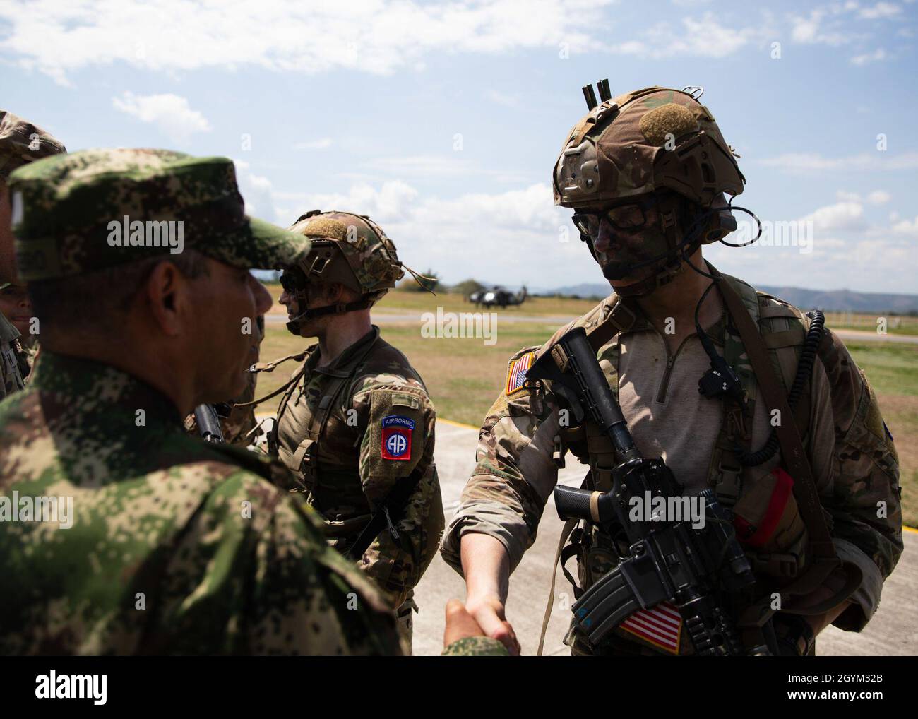 An 82nd Airborne Division Paratrooper shakes hands with Colombian Army ...