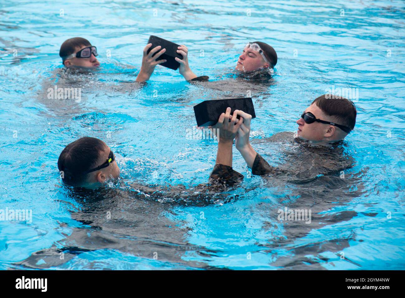 U.S. Marines tread water while holding a brick during water survival ...