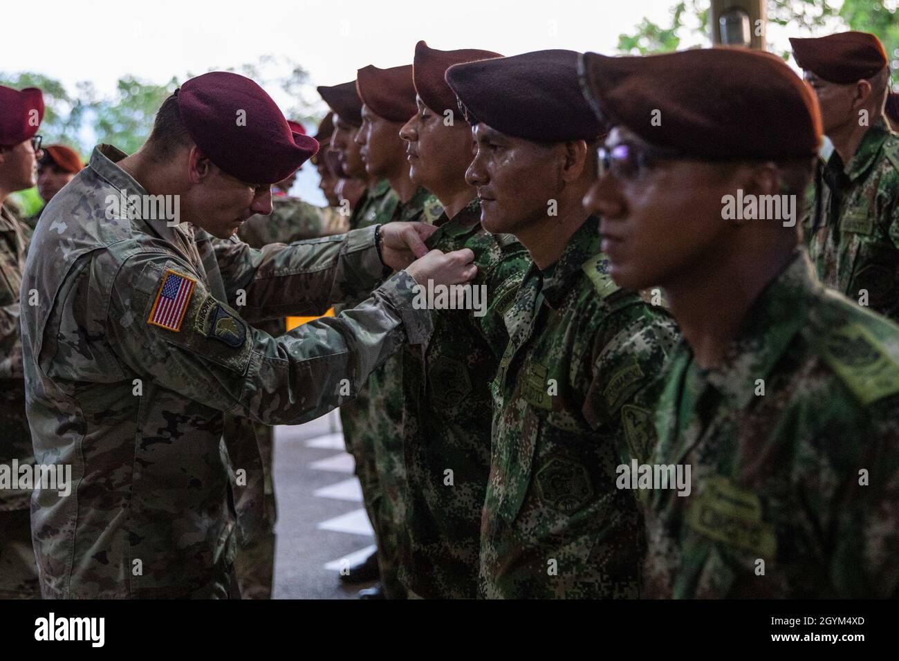 An 82nd Airborne Division officer pins the Army Parachutist Badge on a ...