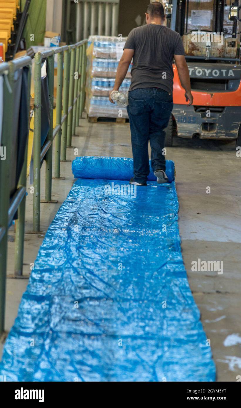 Yauco, PR, January 27, 2020 -- FEMA blue tarps were measured and cut ...