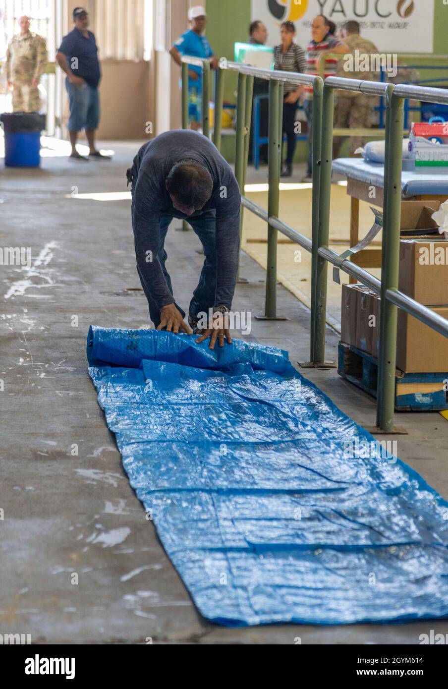 Yauco, PR, January 27, 2020 -- FEMA blue tarps were measured and cut ...