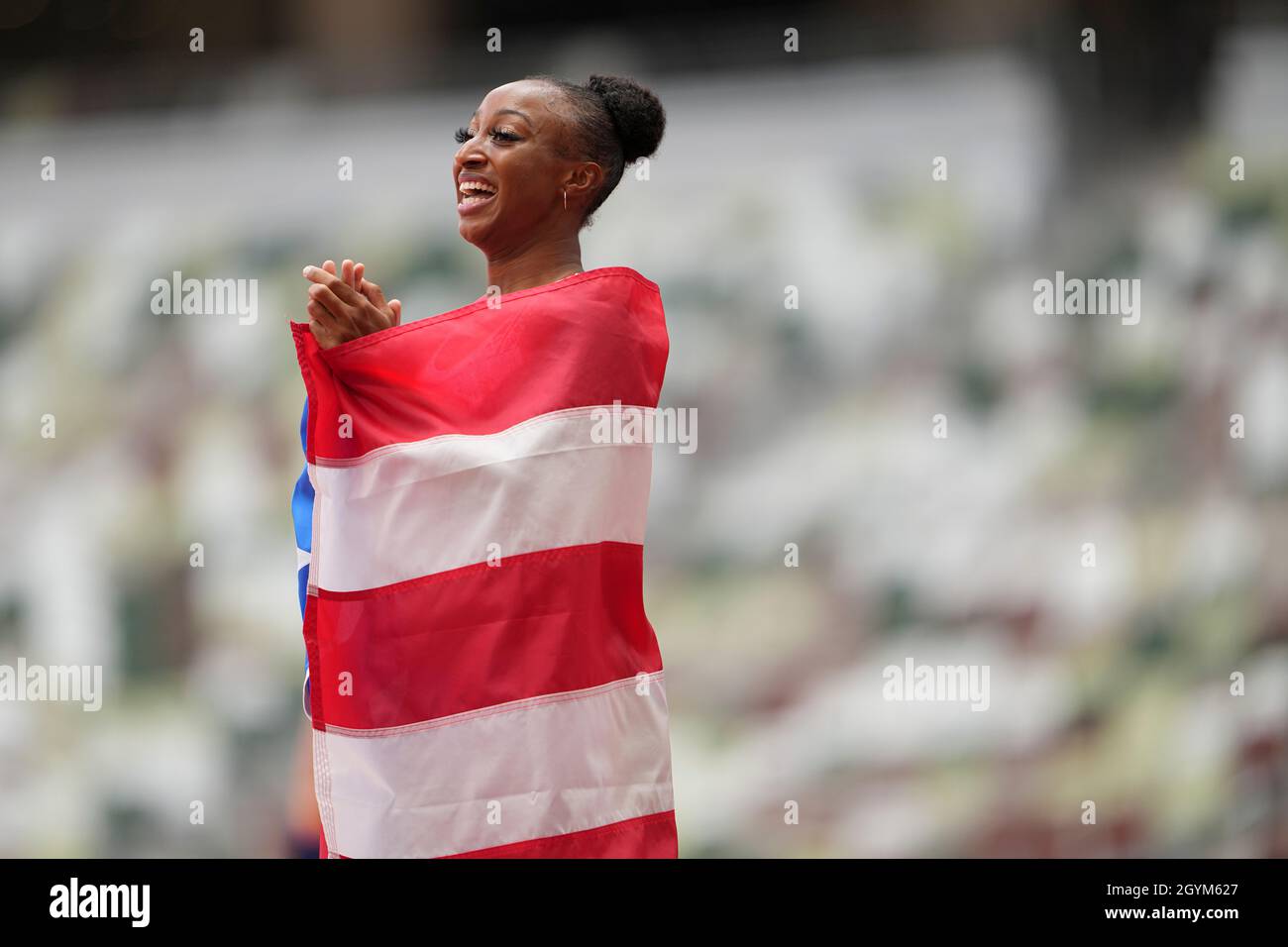 Jasmine Camacho-Quinn with her country's flag after winning gold at the ...