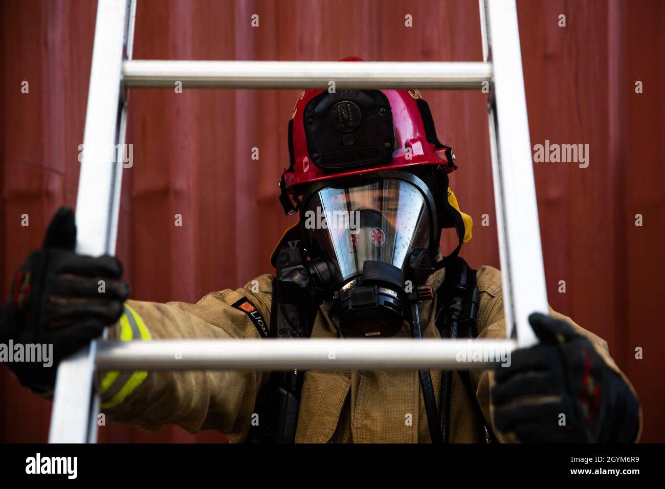 A firefighter with the San Marcos Fire Department holds a ladder in ...