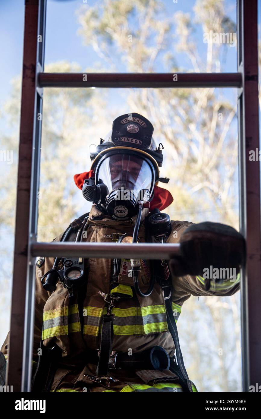 A firefighter with the Rincon Fire Department climbs a ladder during a ...