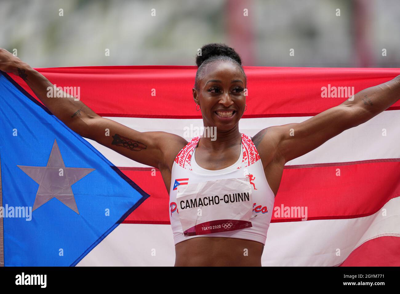 Jasmine Camacho-Quinn with her country's flag after winning gold at the ...