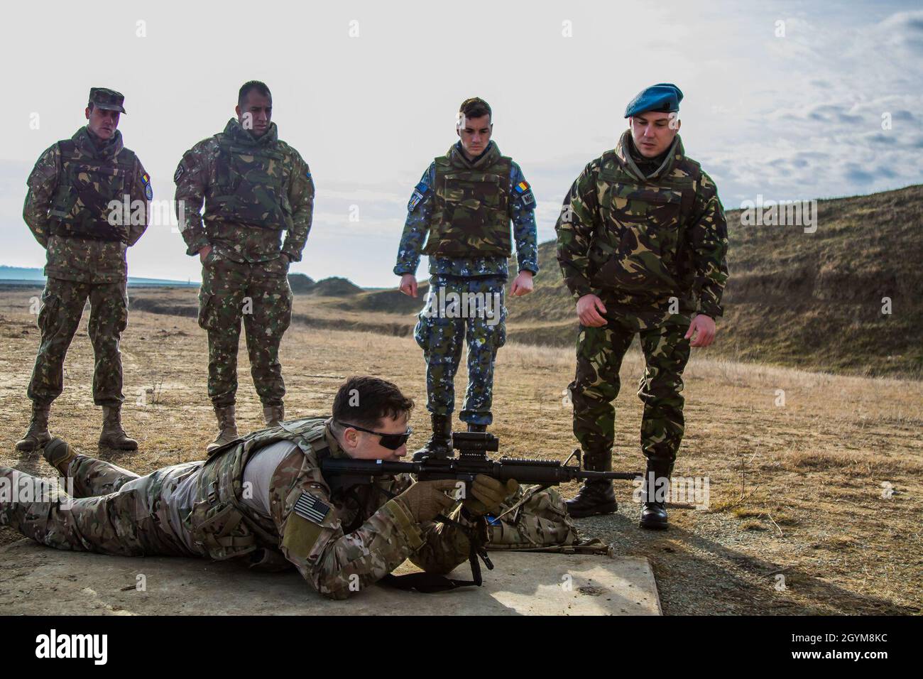 Members of the Romanian armed forces conduct marksmanship training with ...