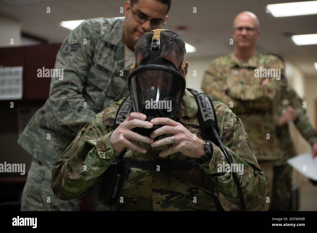 Col. Dan Walls, 23d Wing commander, puts on a breathing apparatus ...