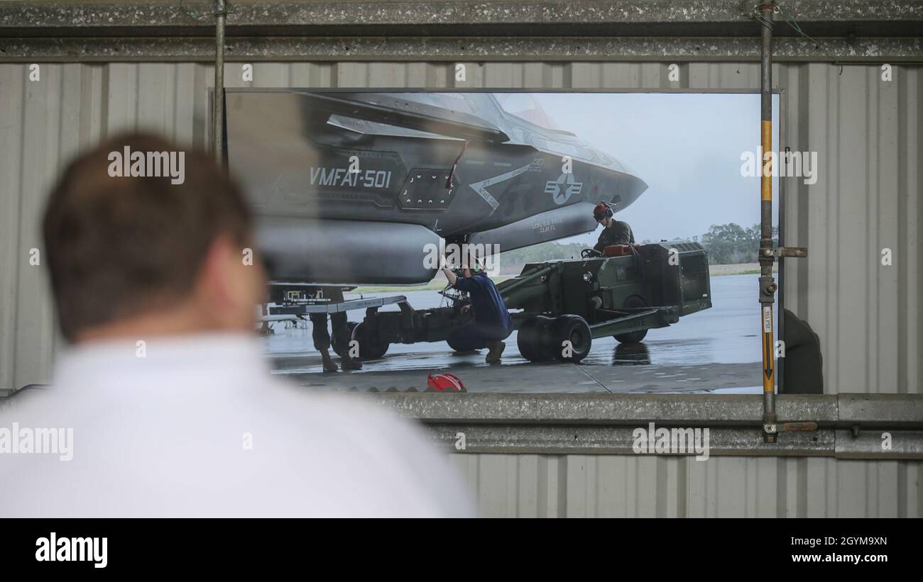 A video plays at the at a ribbon cutting ceremony aboard Townsend ...