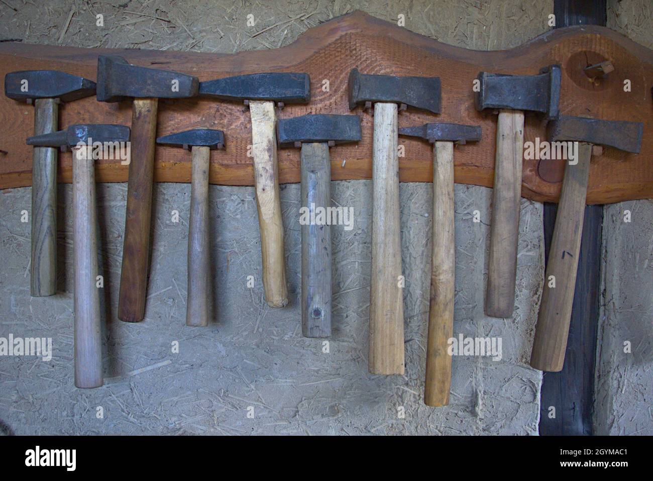 Front view of hammers hanging on the wall Stock Photo - Alamy