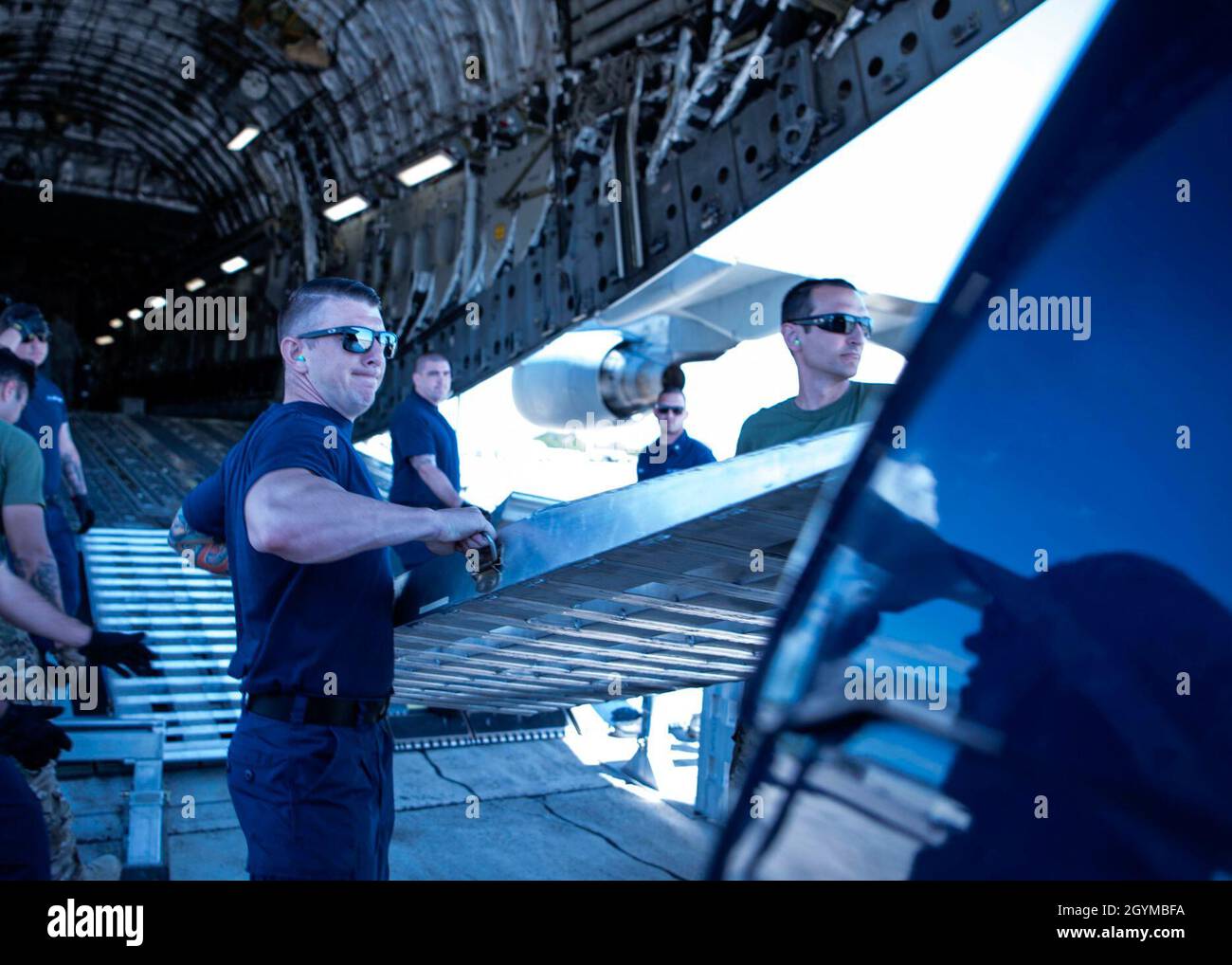 Joint Maritime Safety and Security Teams from the Coast Guard load a ...