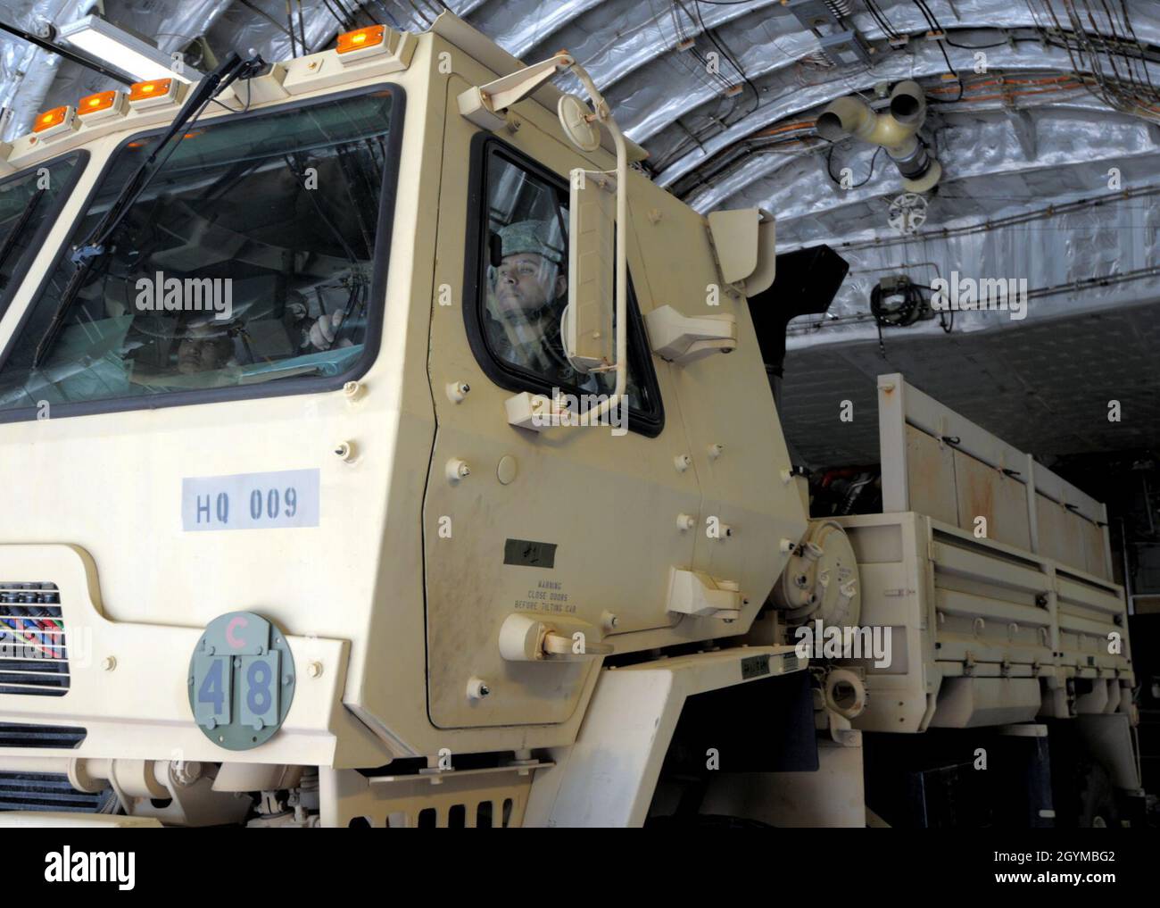 Army Reserve LMTV trucks are offloaded from an Air Force C-17 ...
