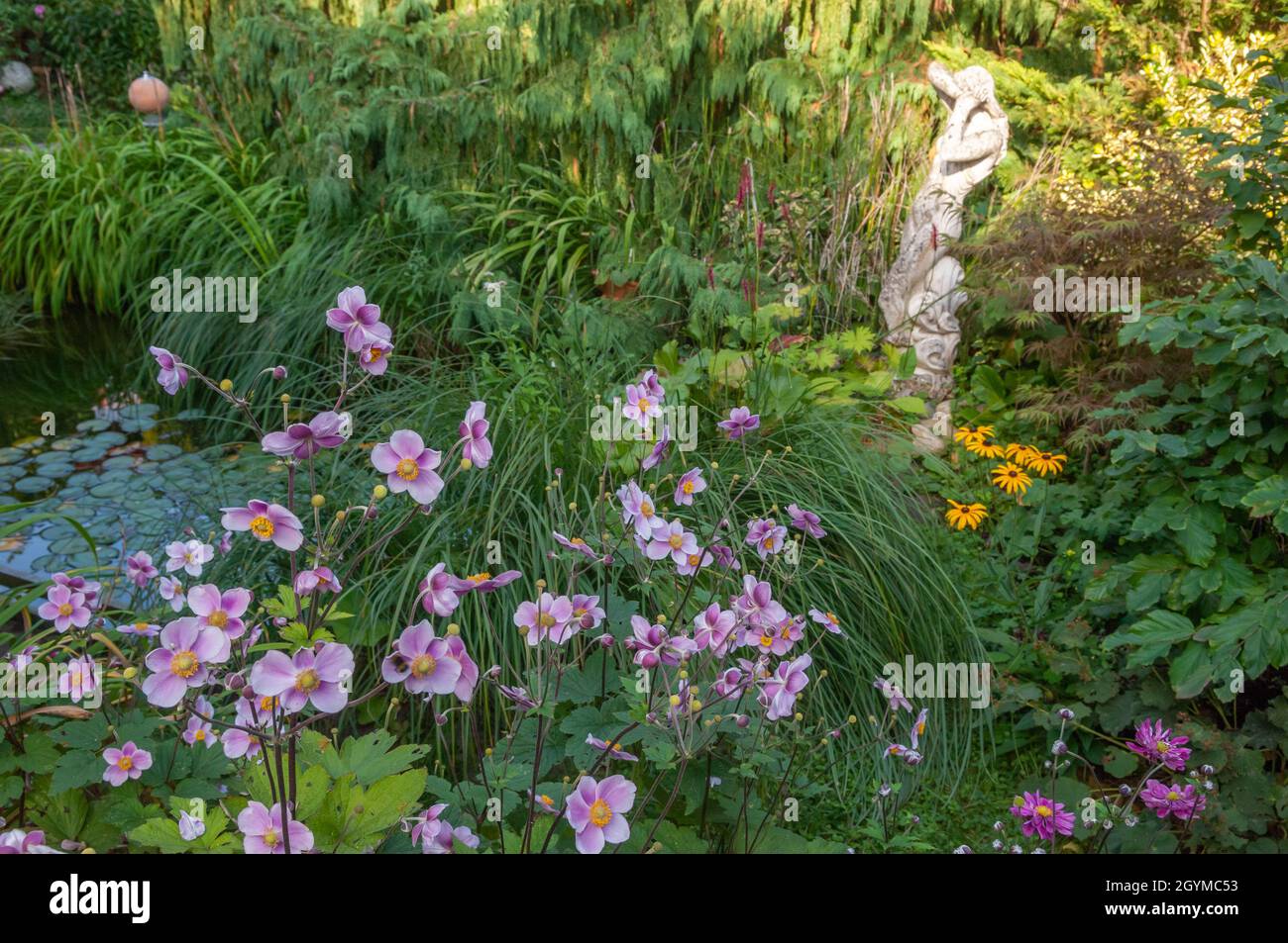 Charm of a Garden blooms in spring. Female statue in decoration Stock ...