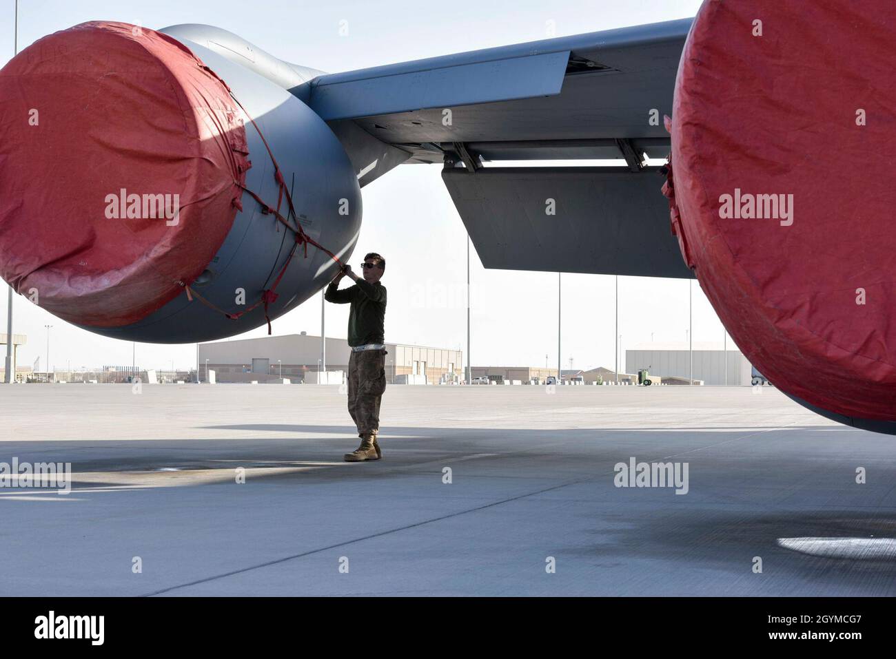 An Airman secures engine covers on a KC-135 Stratotanker at Al Udeid ...