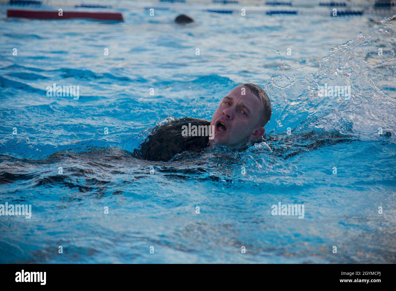 A U.S. Marine performs a 25-meter swim during water survival advanced ...