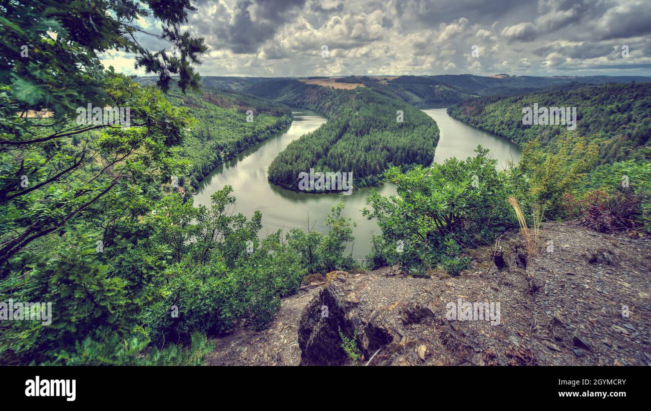 Beautiful landscape view of river flowing through the lands with dense ...