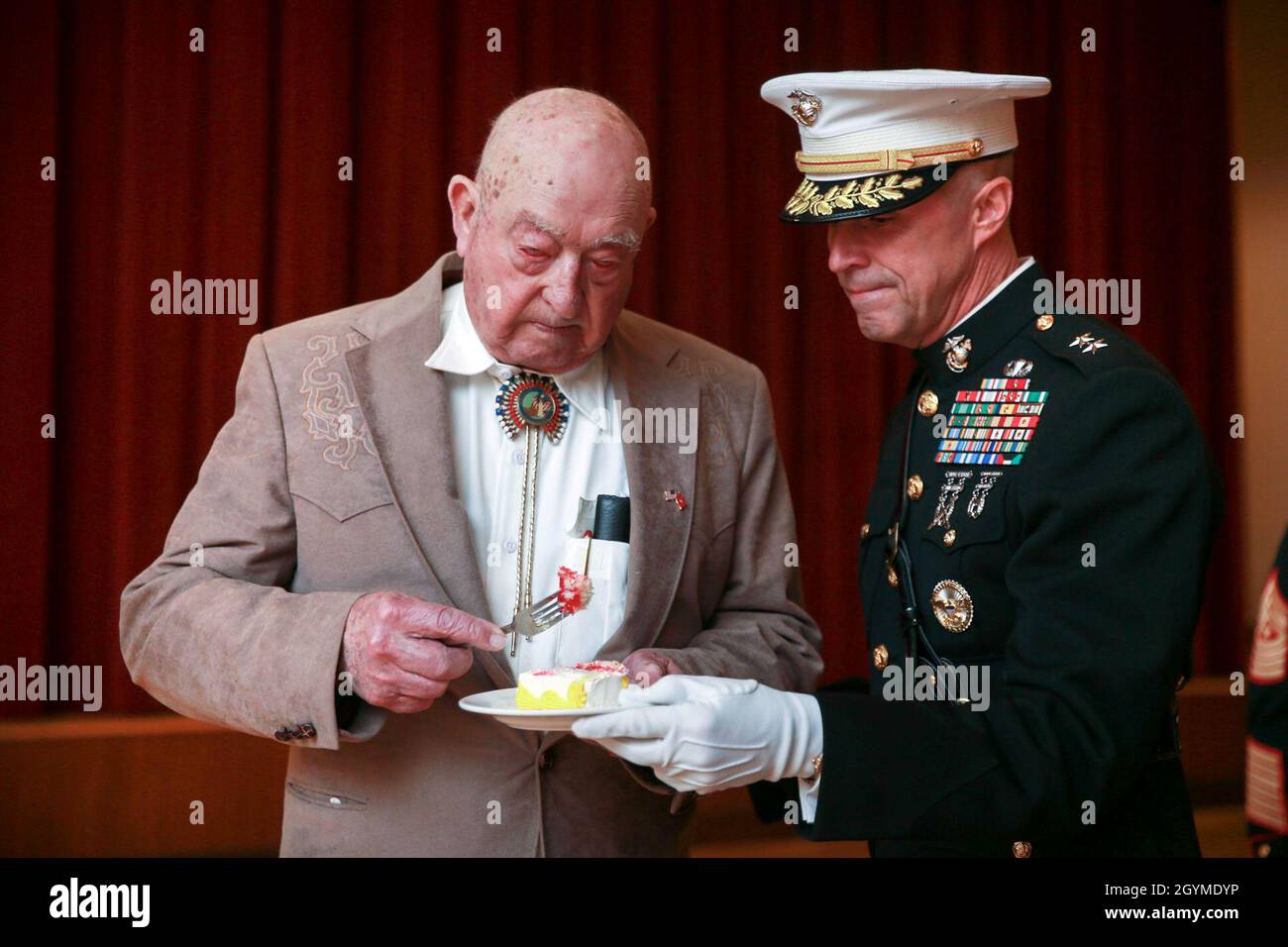 Retired U.S. Marine Corps Pvt. Paul W. Wojahn, left, is presented cake ...