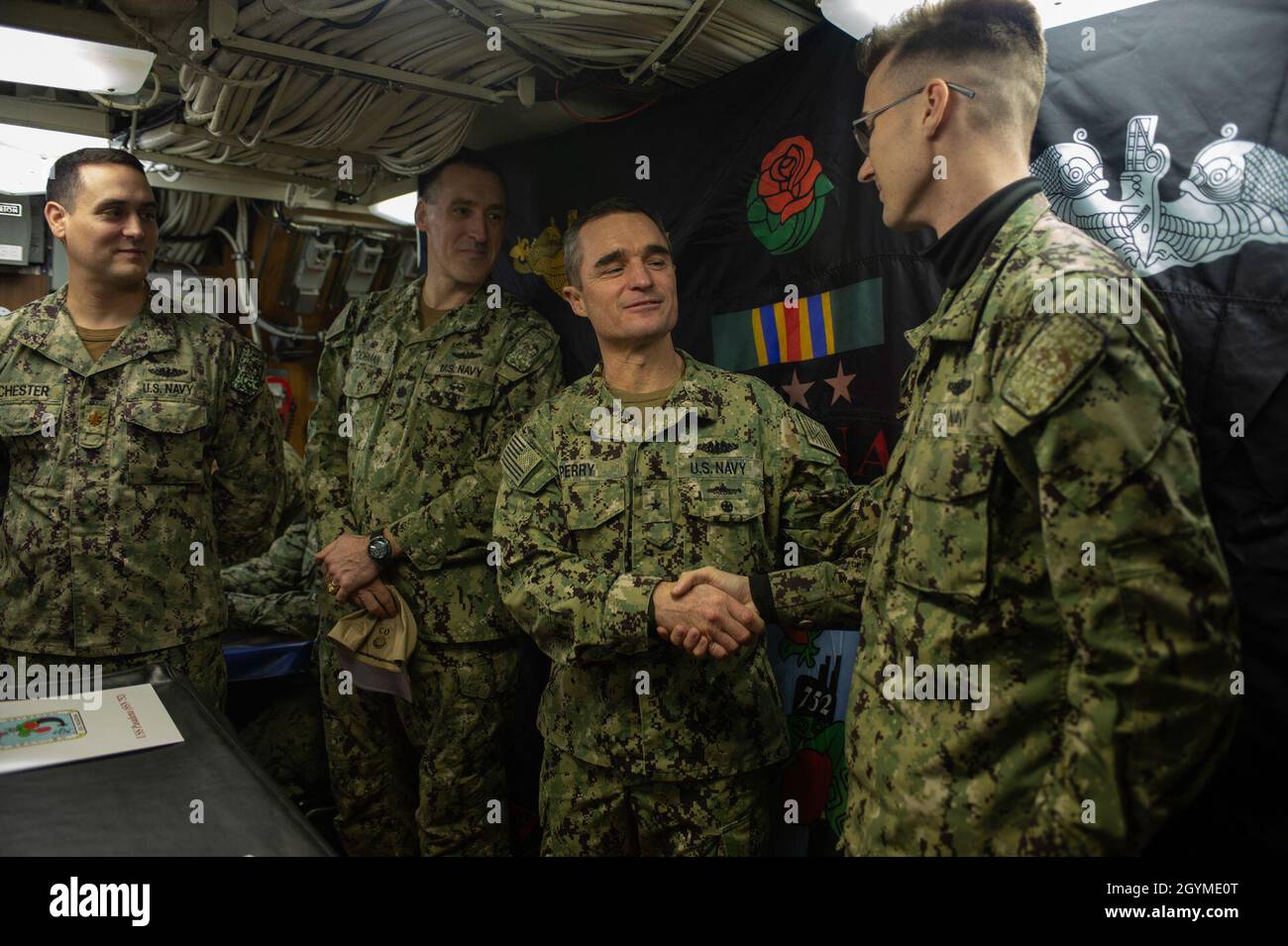 Rear Adm. Doug Perry, Commander, Submarine Group 9, congratulates ...