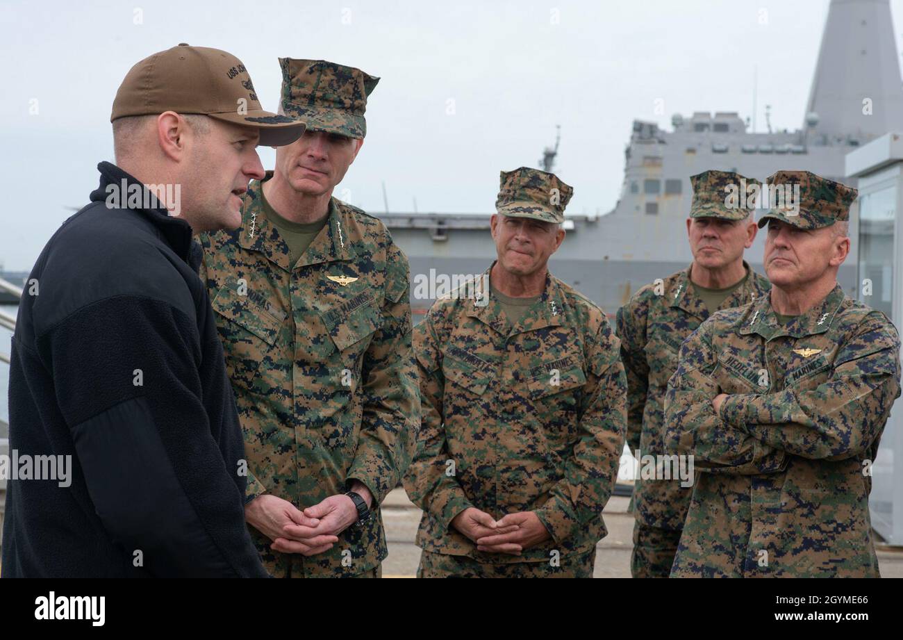 Cmdr. William Wiley, left, commanding officer of USS John Warner (SSN ...